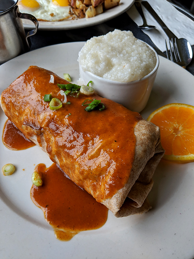 A breakfast burrito smothered in sauce that makes you want to cancel all your plans and dedicate your day to savoring every last bite.