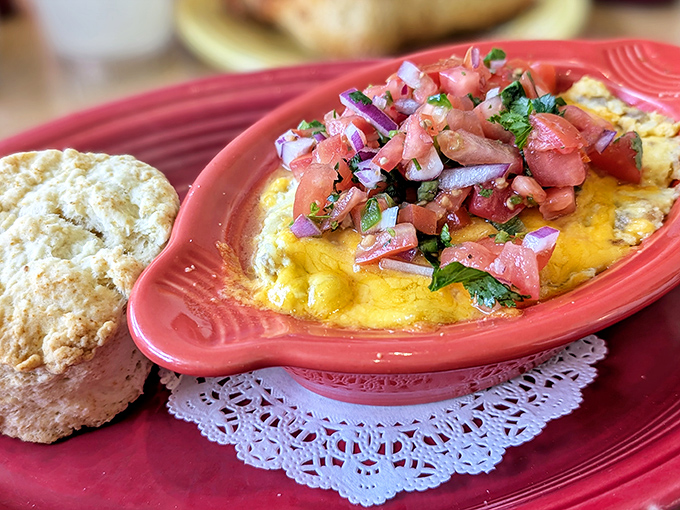 A biscuit so flaky it could make a pastry chef weep, beside a casserole that's basically breakfast's greatest hits album in one dish.