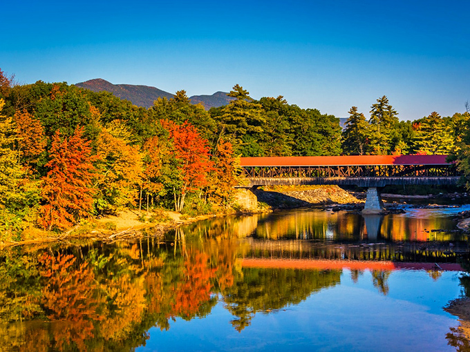 Even bridges dress up for autumn in New Hampshire. This crossing creates perfect symmetry with its reflection, doubling the visual feast.