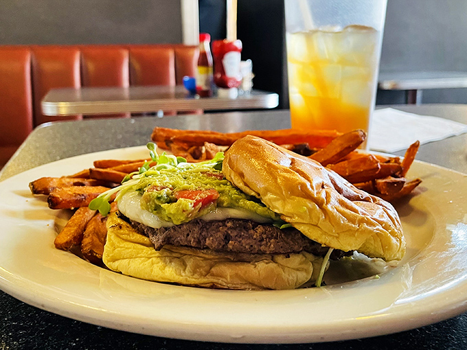 A burger that doesn't care what time it is – topped with a fried egg because at Thumbs Up, breakfast ingredients crash the lunch party too.
