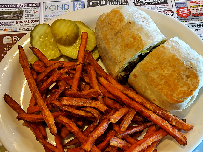 Sweet potato fries that could make a vegetable-hater reconsider their life choices, alongside a burrito that demands a two-handed commitment.