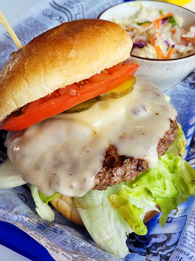 A cheeseburger that doesn't need Instagram filters&mdash;melty cheese cascading over a perfectly seared patty with garden-fresh toppings.