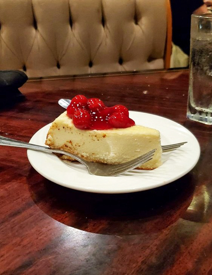 New York cheesecake topped with cherries&mdash;dense, rich, and unapologetic. The kind of dessert that makes you reconsider your belt notch.