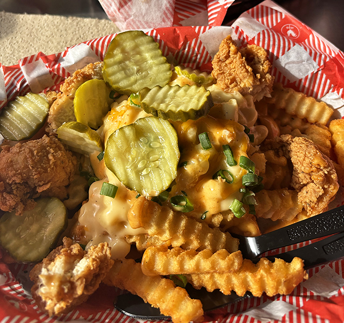 Crinkle-cut fries smothered in cheese with chicken bites and pickles isn't a snack&mdash;it's what happens when comfort food gets dressed for a Nashville night out.