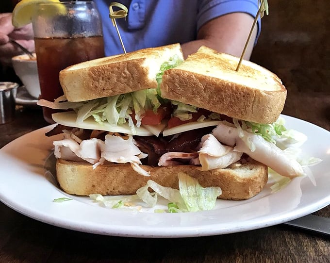 The club sandwich that towers so high it needs those toothpicks for structural support. Layer upon layer of satisfaction between perfectly toasted bread.