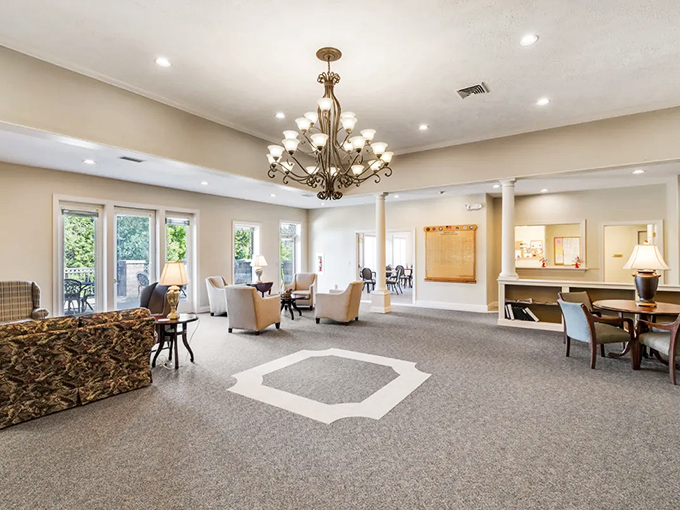 A community living room that's actually designed for living. That chandelier has illuminated more new friendships and card game victories than any cruise ship social director. 