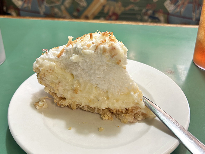 Coconut cream pie with a meringue so light it might float away if not anchored by that perfect custard filling. Fork included for emergency landings.