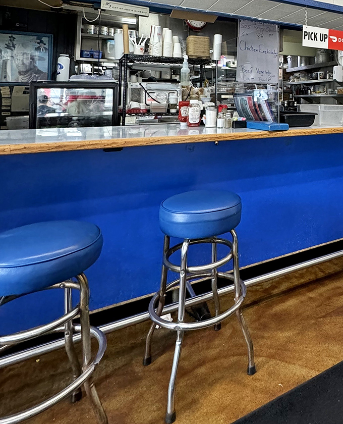 The blue counter and classic stools invite solo diners to perch and watch the breakfast ballet unfold&mdash;front-row seats to culinary theater.