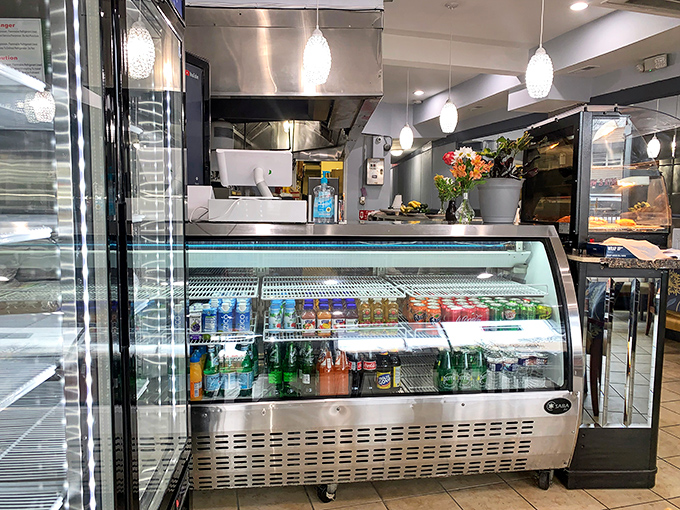The beverage case stands ready with colorful refreshments, perfect companions for navigating the delicious heat of Ethiopian spices.