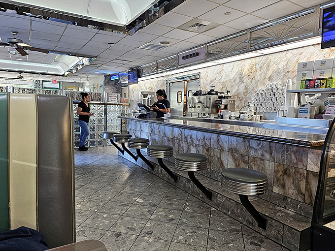 The counter where breakfast magic happens, complete with classic swivel stools&mdash;the front-row seats to the greatest show on Hilton Head: breakfast.