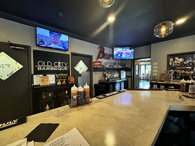 The bar counter gleams with promise, while those sauce dispensers stand ready to elevate your meat to the next level.