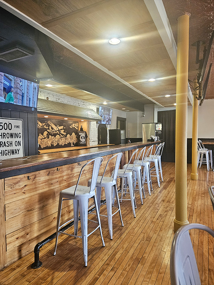 The wooden bar with its row of blue metal stools practically begs you to pull up, order a burger, and make friends with whoever sits next to you.