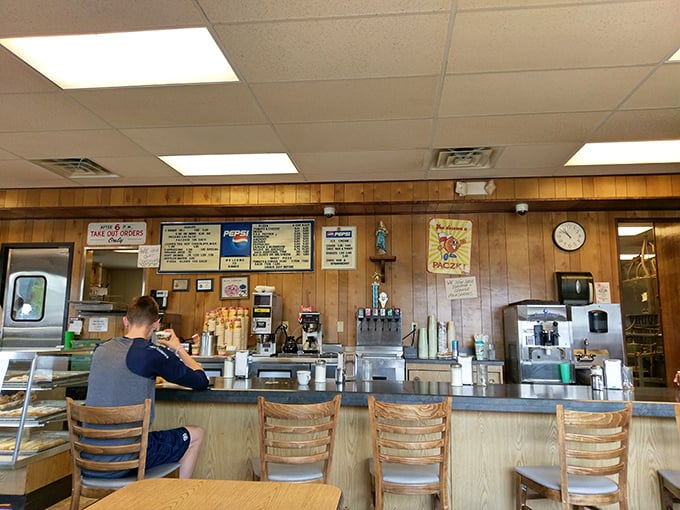 The counter where magic happens&mdash;simple, efficient, and staffed by people who understand that good mornings begin with great donuts.