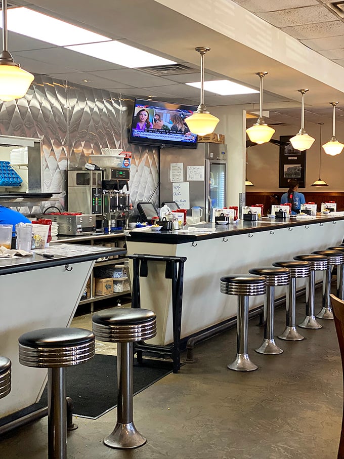 The classic diner counter with chrome stools - where regulars perch for their morning coffee and servers know everyone by name.