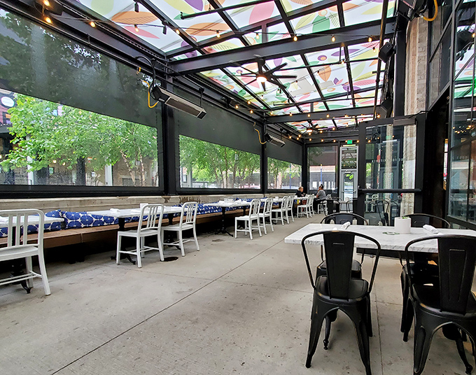 The covered patio offers al fresco dining with a twist of whimsy overhead. Those colorful panels filter sunlight into an artistic experience for diners below.