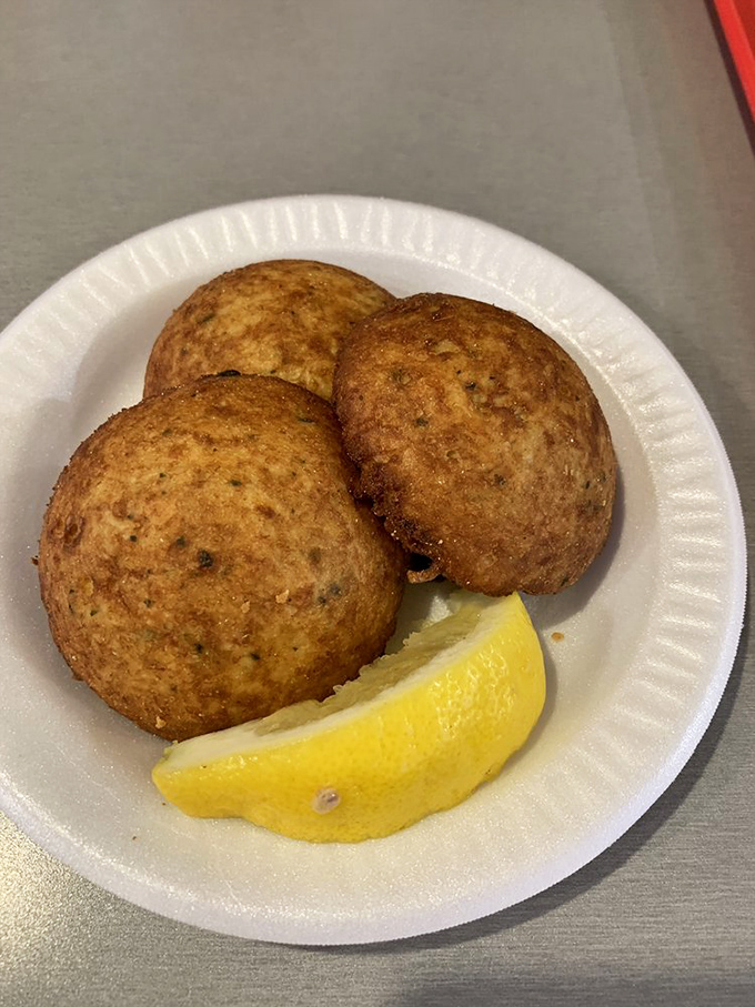 Crab cakes golden as a summer sunset, with a lemon wedge standing by for duty. Simple perfection on a paper plate.
