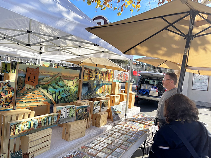 Handcrafted wooden art pieces line this booth like a gallery where you're actually encouraged to touch the merchandise&mdash;and take it home.