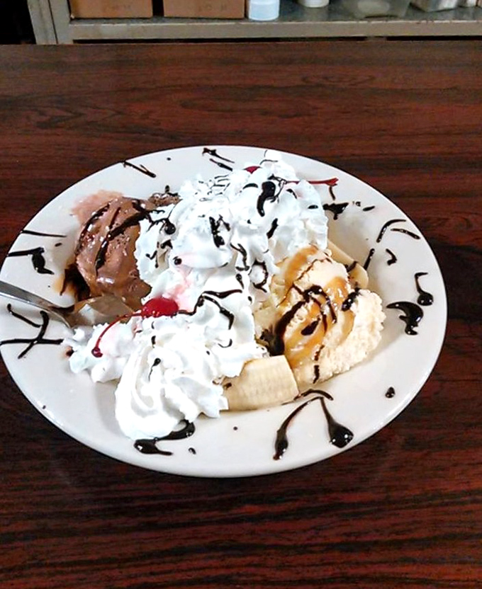This banana split isn't just dessert &ndash; it's a childhood memory served on a plate, complete with whipped cream mountains and chocolate rivers.