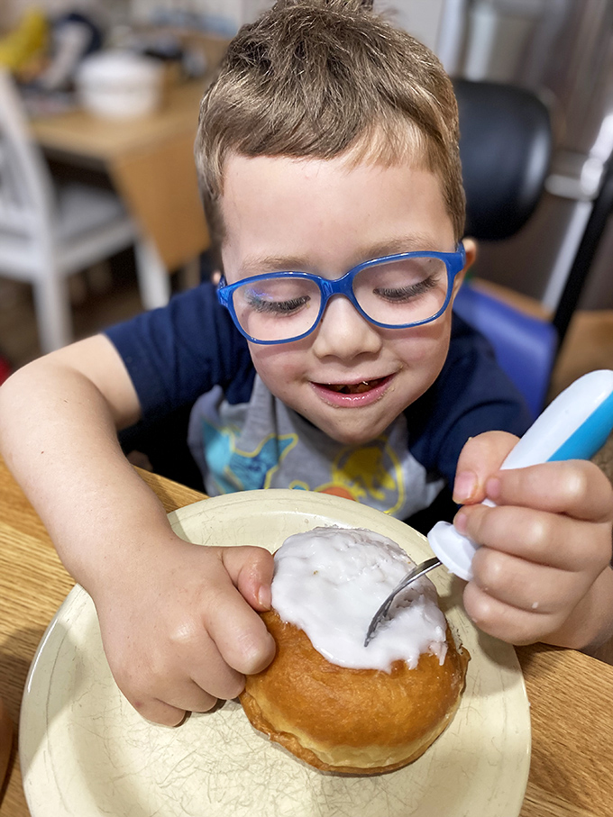 The look of pure joy when a young explorer discovers the magic of a perfectly frosted donut. Future regular in training.