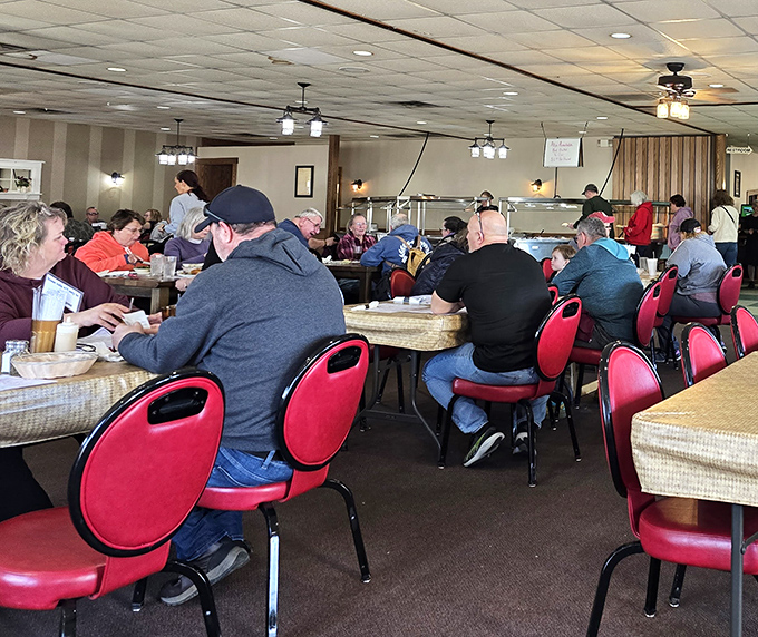 A dining room filled with happy eaters, all participating in the universal ritual of "the silent nod of food approval."