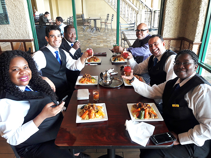 Good food brings people together, as evidenced by this cheerful group raising their glasses in a toast to Moroccan hospitality in the heart of Florida.