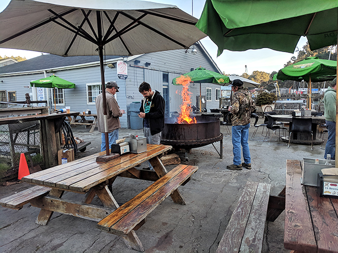 The outdoor dining area where strangers become friends, united by fire pits, picnic tables, and the universal language of "pass the malt vinegar."