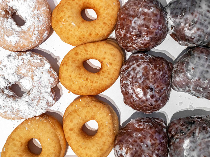 A box of possibilities&mdash;where powdered, glazed, and chocolate-dipped neighbors coexist in perfect harmony, waiting for your impossible decision.