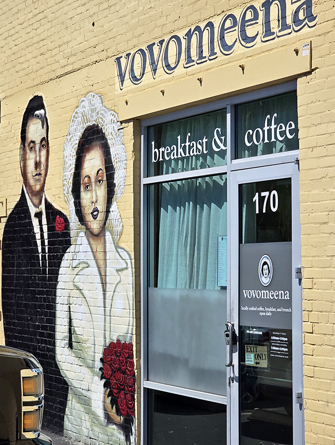 The distinctive mural on the yellow exterior wall serves as both landmark and conversation starter. "Meet me at the couple on the wall."