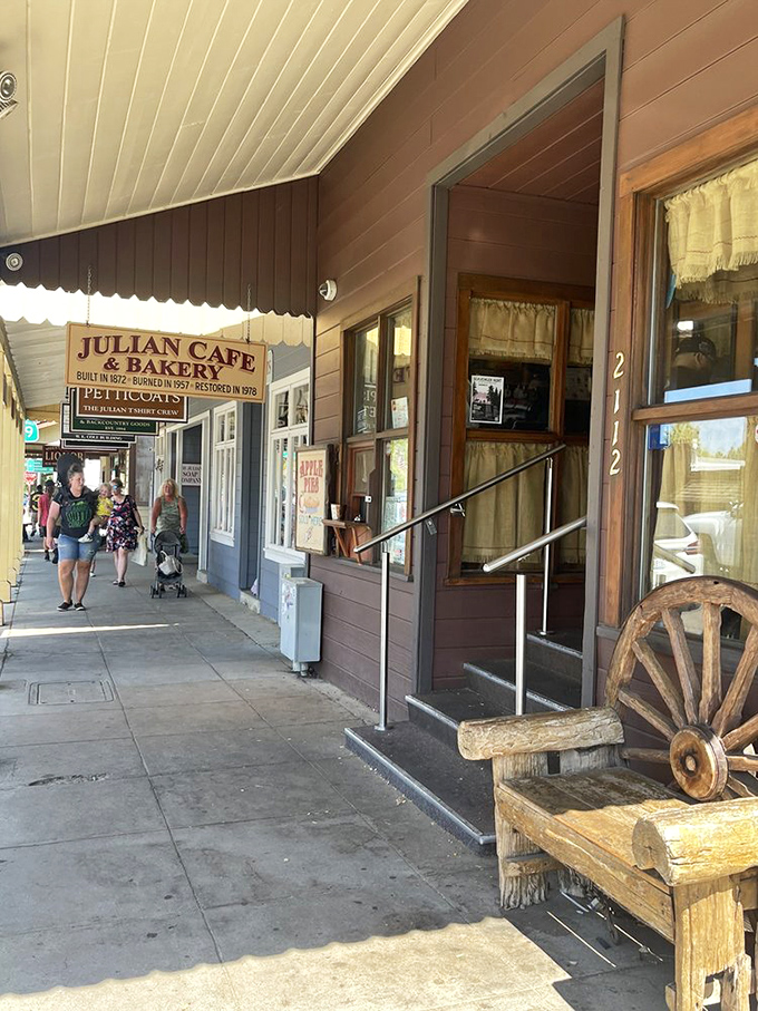 A rustic wooden bench and wagon wheel outside the entrance set the stage for the time-traveling culinary experience that awaits.