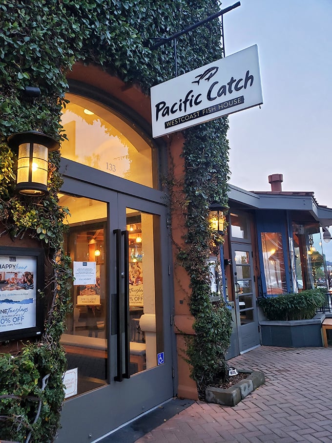 The entrance beckons like a portal to coastal flavors. That ivy-covered doorway is practically whispering, "Your diet starts tomorrow."