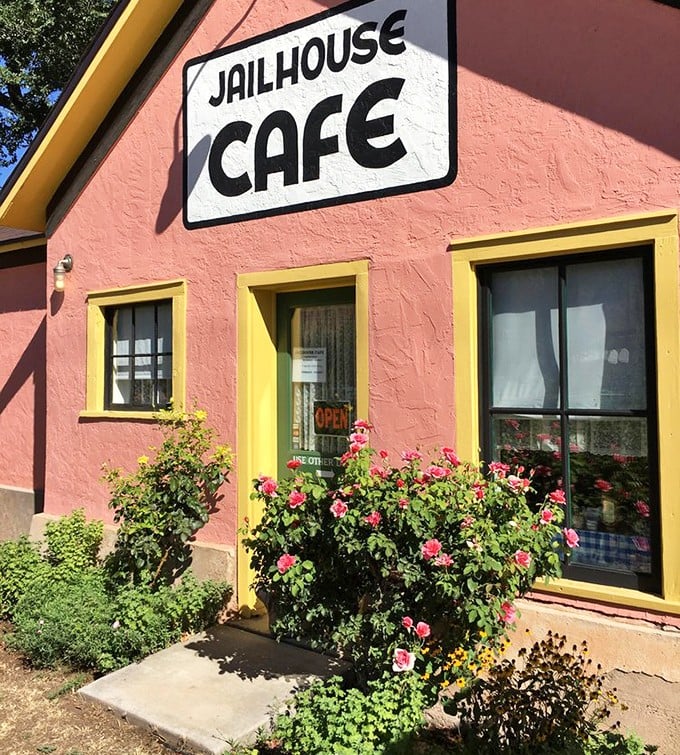 Pink walls framed by yellow trim and accented with blooming roses&mdash;this entrance says "come for the novelty, stay for the food." A warm welcome to breakfast paradise.