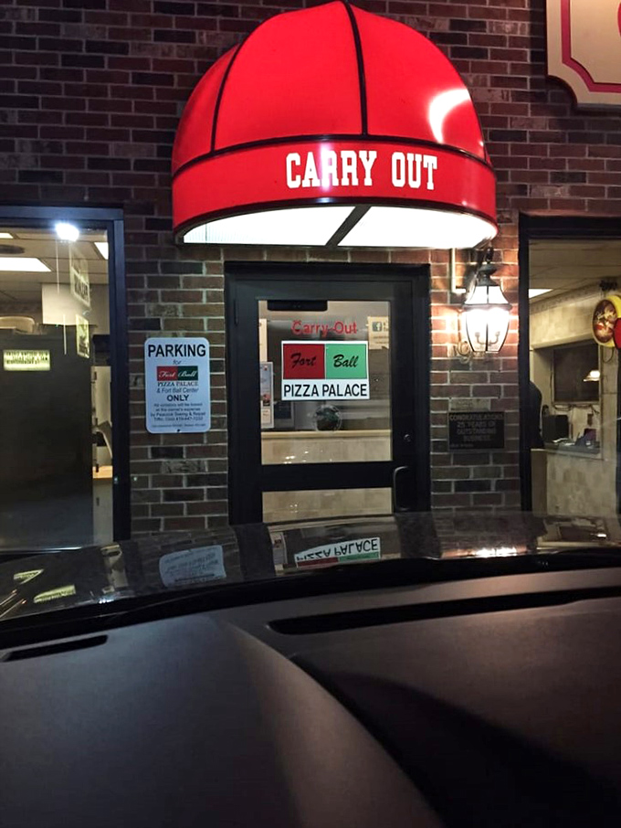 The "Carry Out" entrance glows like a beacon of hope for those who prefer their pizza parties in pajamas at home.