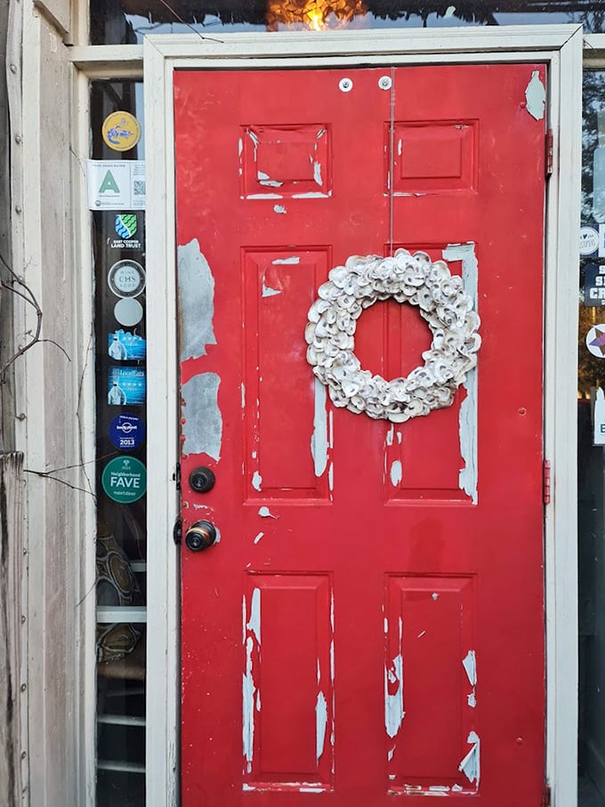 That weathered red door with its oyster shell wreath isn't just an entrance &ndash; it's a portal to one of South Carolina's most beloved seafood experiences.