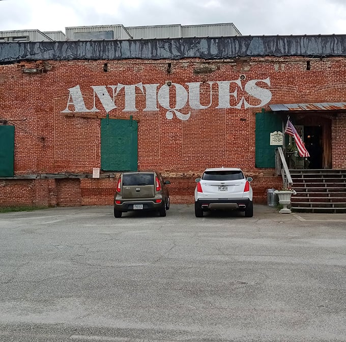 The exterior view that says, "Yes, we're serious about antiques" with all the subtlety of a brick wall&mdash;because it literally is a brick wall with "ANTIQUES" painted on it.
