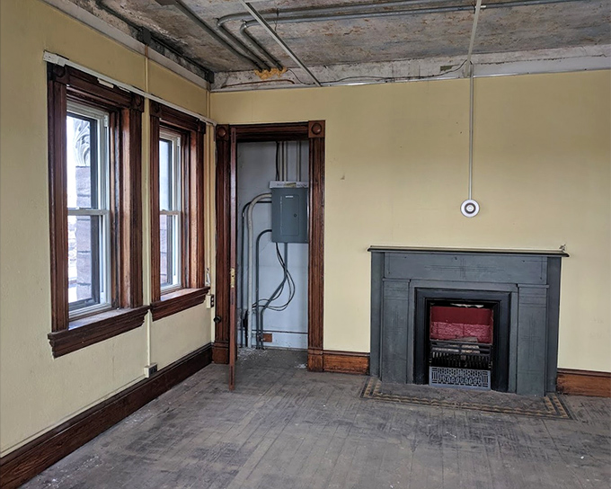 The sheriff's quarters offered relative luxury with wooden trim, large windows, and this fireplace&mdash;a stark contrast to the spartan cells just steps away.