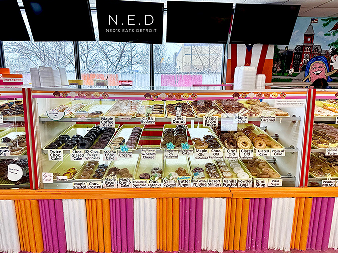 The display case of dreams. Each labeled section represents a different pathway to happiness, all under bright lights and clear glass.