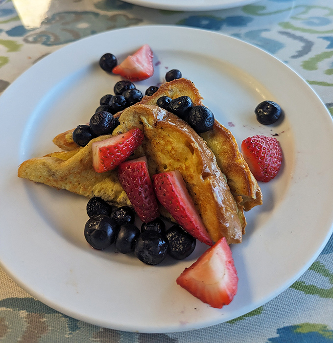 French toast adorned with fresh berries, because sometimes breakfast deserves to dress up for the occasion.