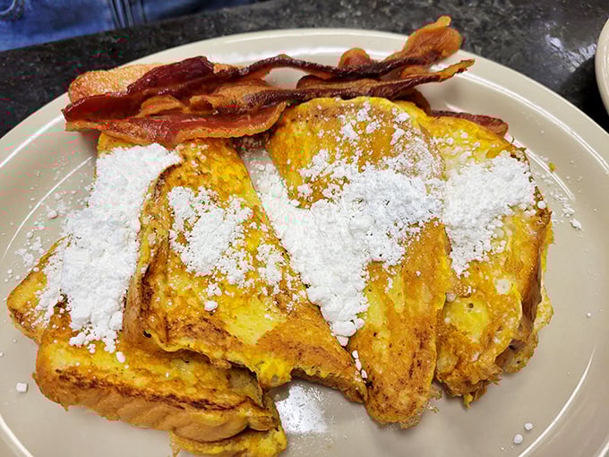 French toast that's had a proper powdered sugar snowfall. With bacon standing guard to ensure the perfect sweet-savory balance.