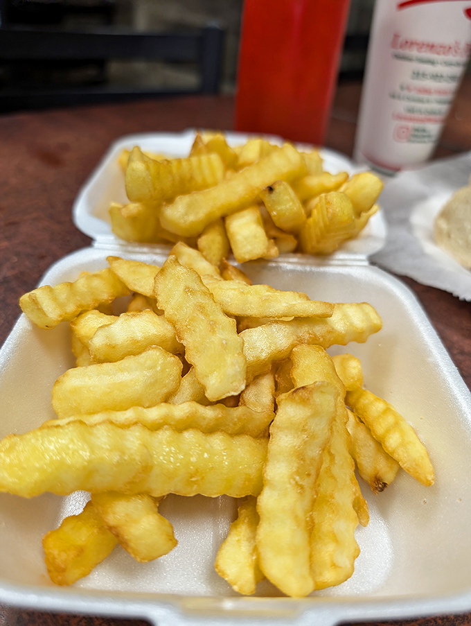 Golden, crispy fries that crackle with each bite—the perfect supporting actor to Lorenzo's star sandwich attractions.