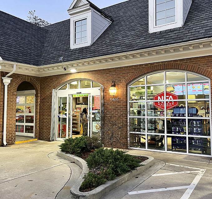 The welcoming storefront glows like a beacon for burger lovers. Those arched windows frame a promise of deliciousness waiting inside.