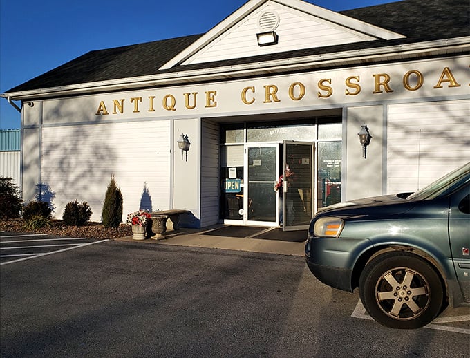 The unassuming exterior belies the wonderland within. Antique Crossroads announces itself with golden letters against white clapboard simplicity.