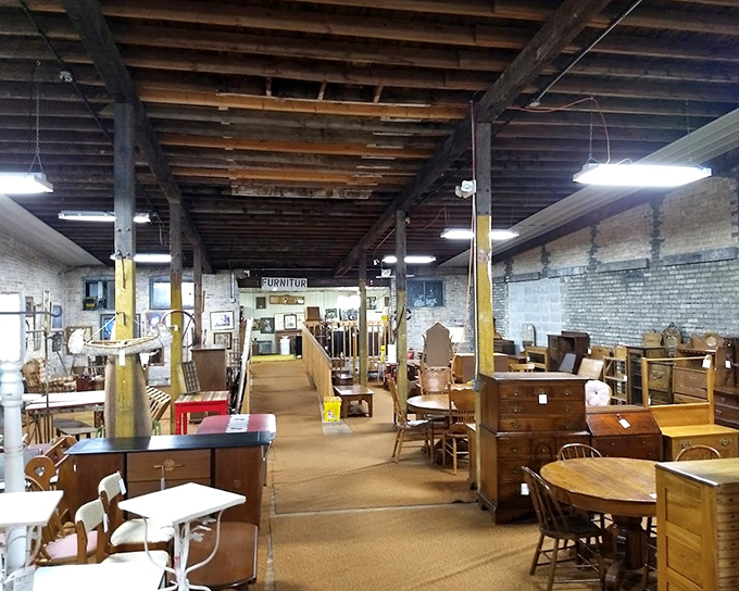 Exposed brick and wooden beams frame this furniture gallery where every table has already hosted thousands of family dinners.