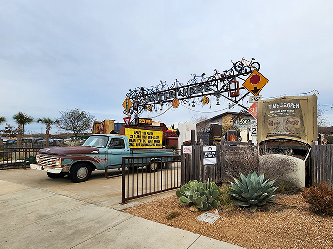 Bicycles, road signs, and vintage vehicles adorn the gate, setting the tone for the creative repurposing inside.