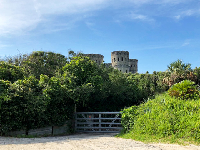 Beyond the rustic gate, Castle Otttis rises from the landscape&mdash;a stone mirage that seems to float above the Florida greenery.