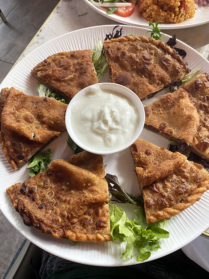 Golden-brown goshnan flatbread, served with cooling yogurt, offers the perfect introduction to Uyghur cuisine's masterful way with dough and savory fillings.