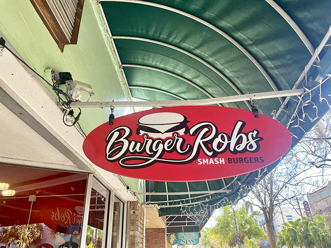 The iconic BurgerRobs sign hangs like a promise against the Florida sky, beckoning hungry travelers to the promised land of smashed burger perfection.