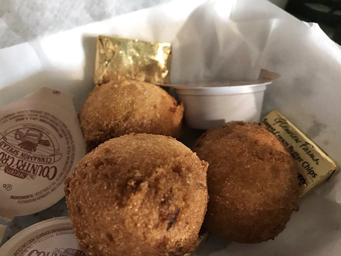 Hush puppies golden as buried treasure, with a cornmeal crunch that whispers sweet nothings to your taste buds.
