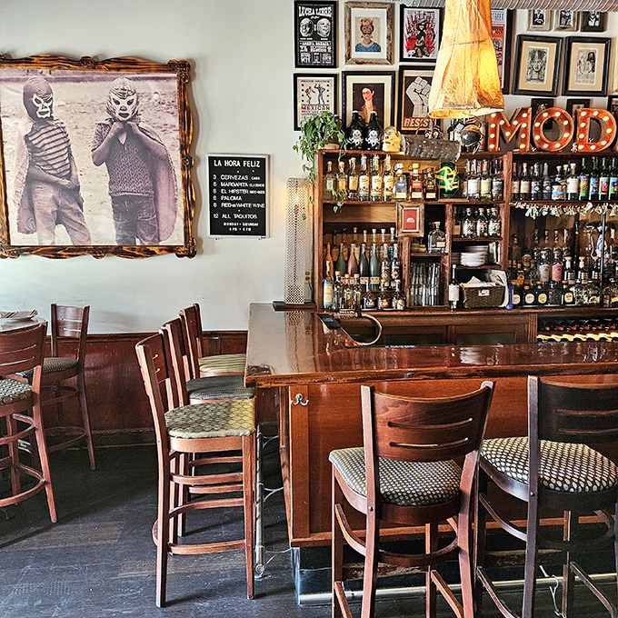 Vintage Mexican wrestling imagery watches over diners&mdash;silent guardians of a bar area that balances quirky nostalgia with serious tequila business.