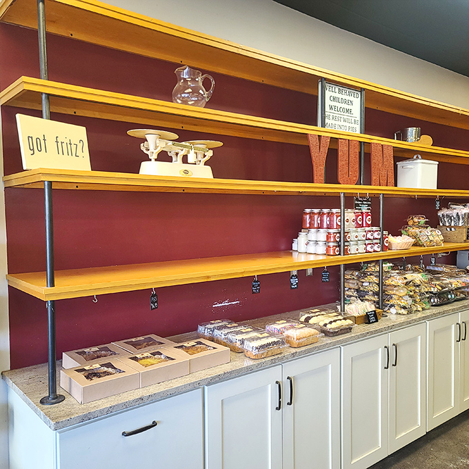 Wooden shelves and burgundy walls create the perfect backdrop for sweet treasures. The "got fritz?" sign suggests you're not fully living until you've tried their goods.