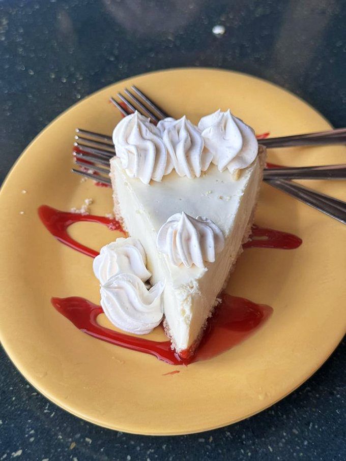 Key lime pie so authentic it should come with its own Florida citizenship, topped with whipped cream clouds on a sunshine-yellow plate.